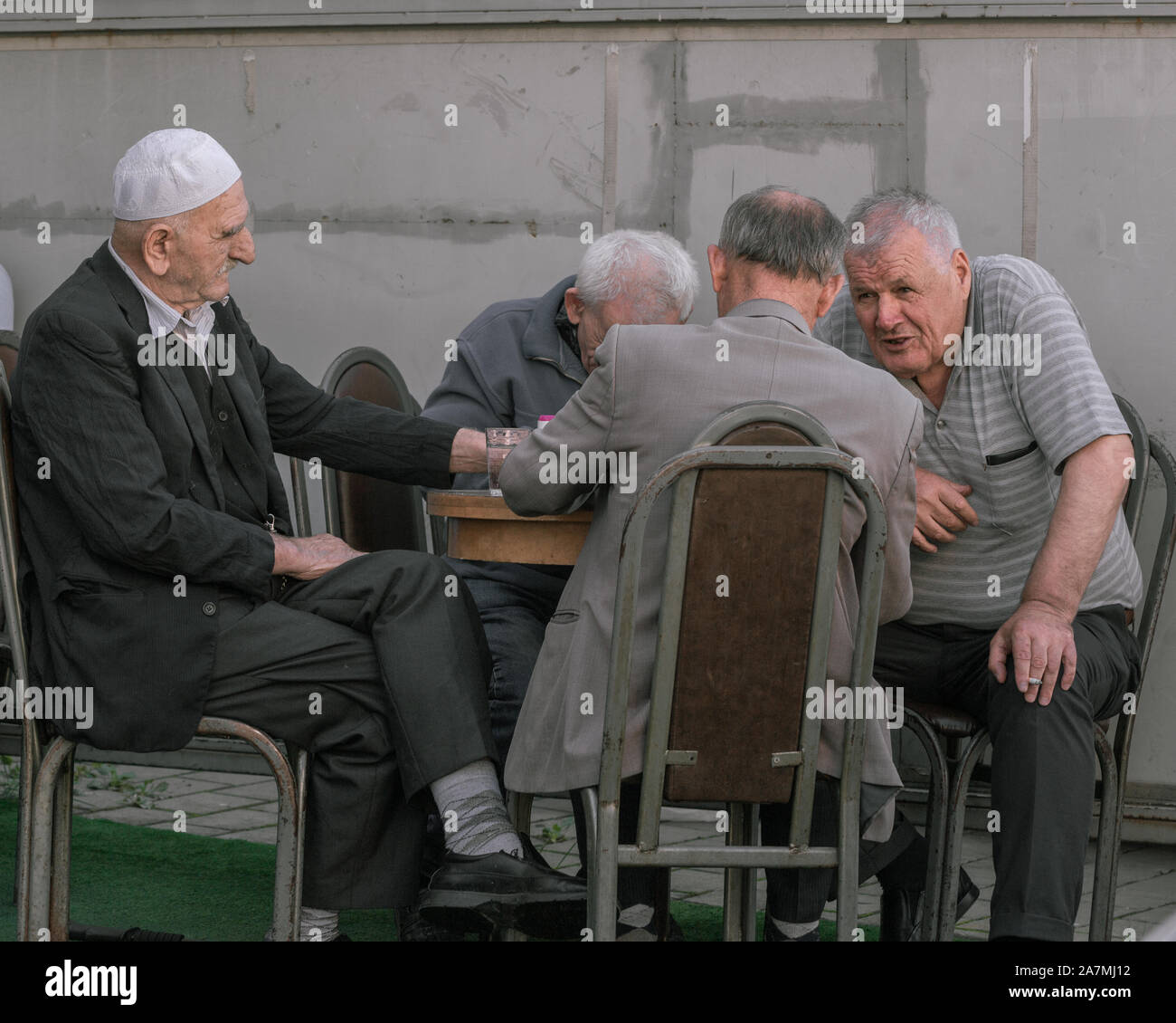 Old man in Pristina street having a conversation. Everyday Kosovo Stock ...