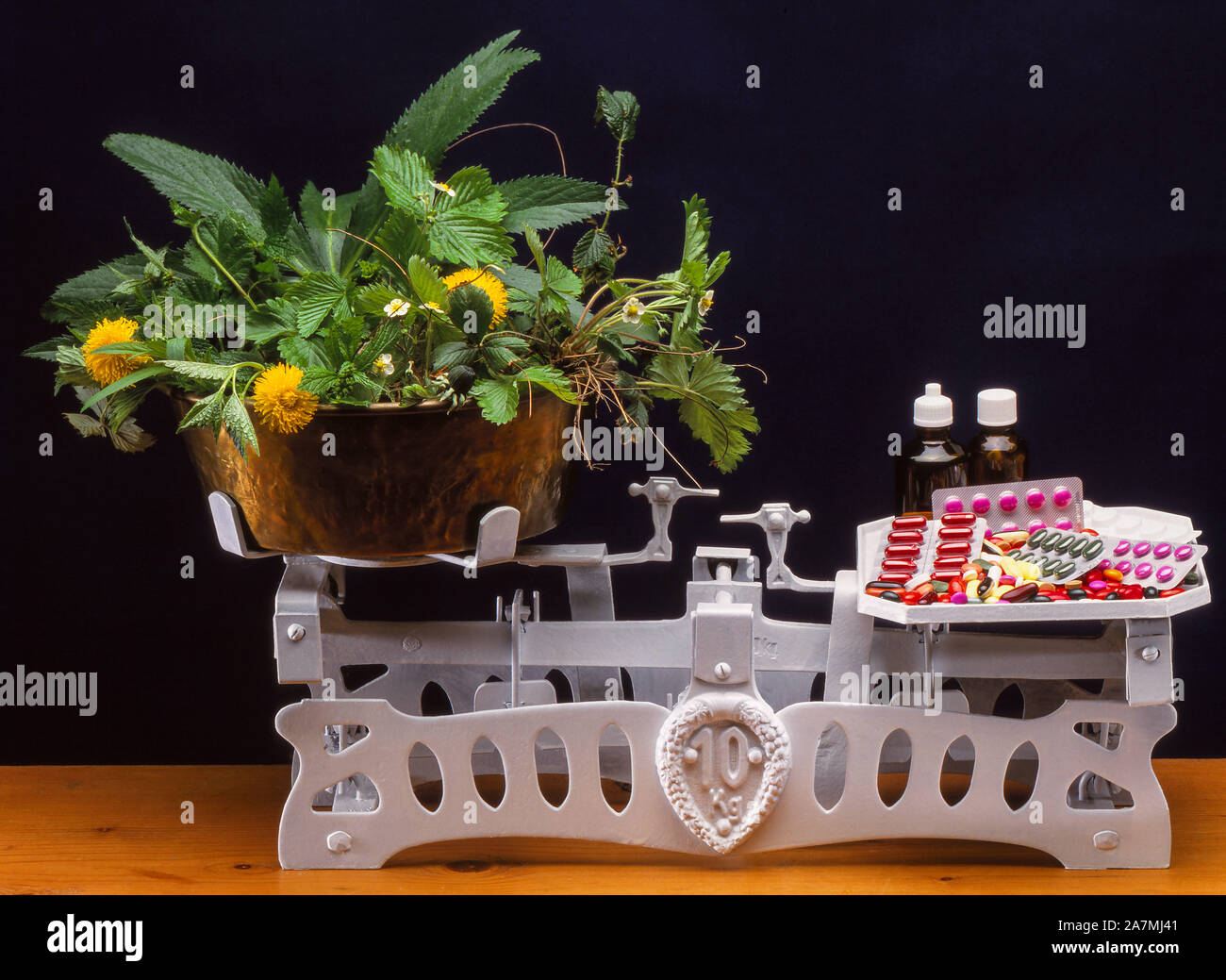 Scale with herbs and medicines, symbol of alternative medicine and ...