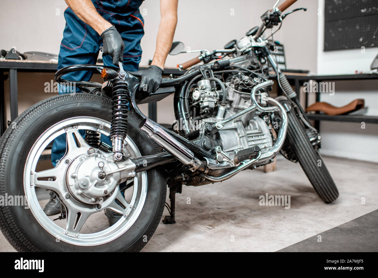Biker or professional workshop worker repairing a beautiful vintage ...
