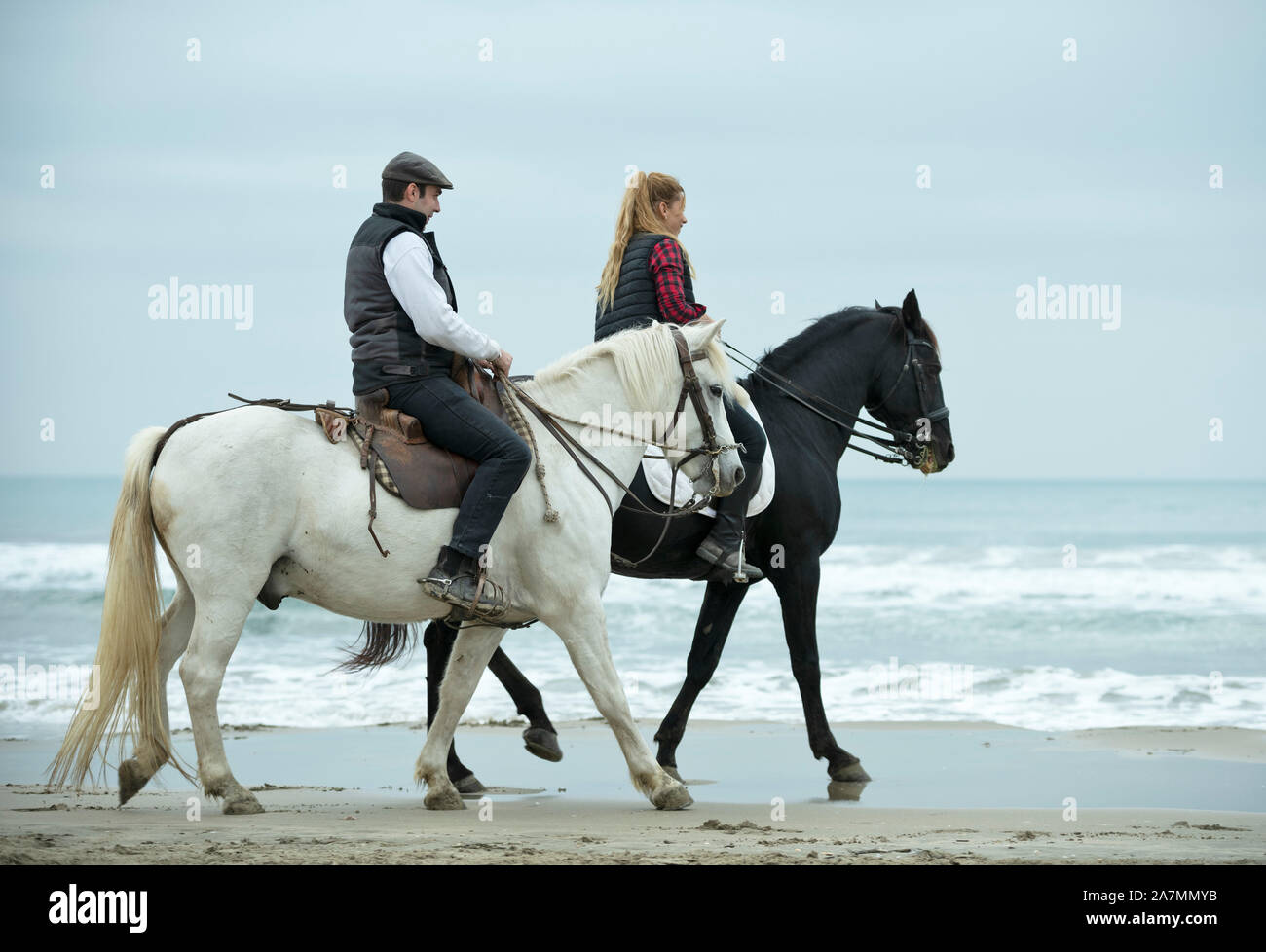Two horse riders on beach hi-res stock photography and images - Alamy