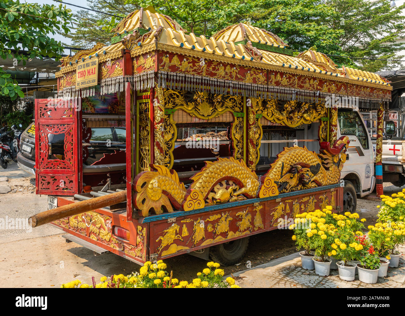 Da Nang, Vietnam - March 10, 2019: Van rebuilt as gold-red hearse with ...