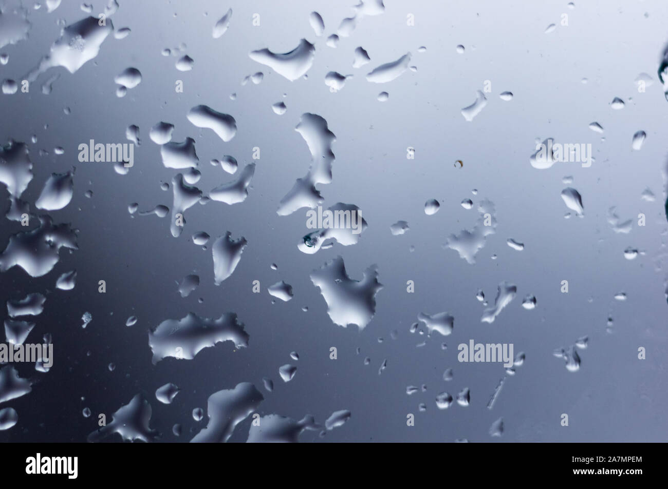 glass in the window covered with wet melting snow, close-up, macro ...