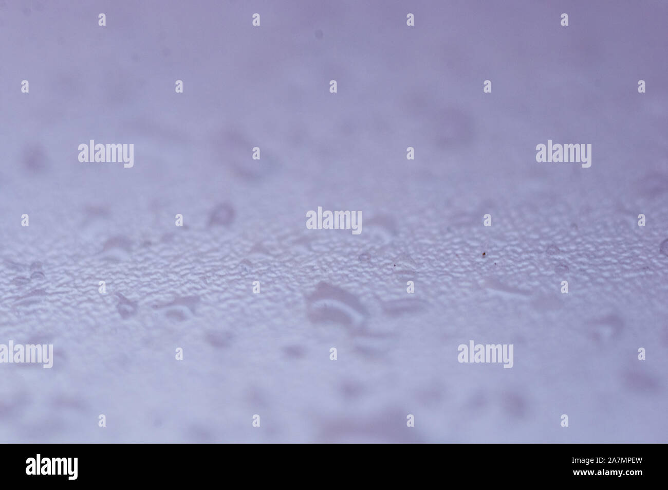 glass in the window covered with wet melting snow, close-up, macro ...