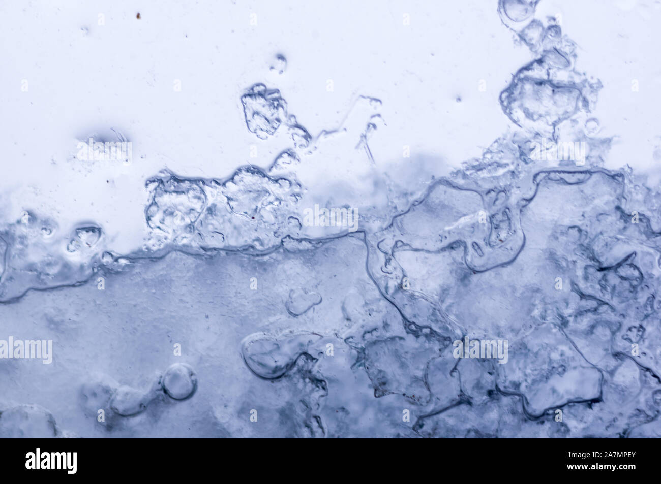 glass in the window covered with wet melting snow, close-up, macro ...