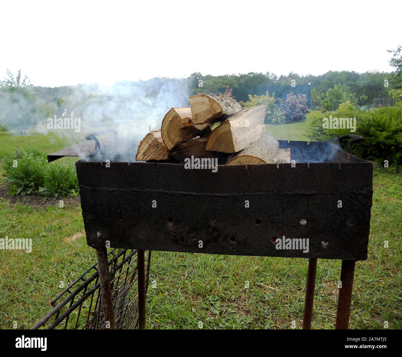 Beautiful red fire from slice wood, dark grey black coals inside metal ...