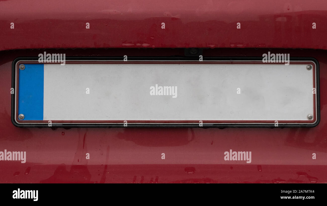 Empty License plate on the back of a red car Stock Photo - Alamy