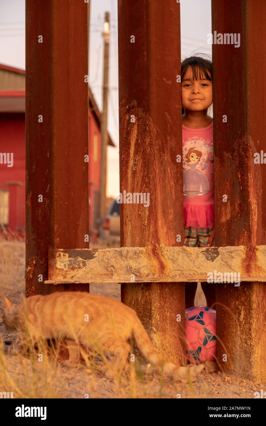 Children play on the Mexican side of the US Mexican border wall, Trump ...