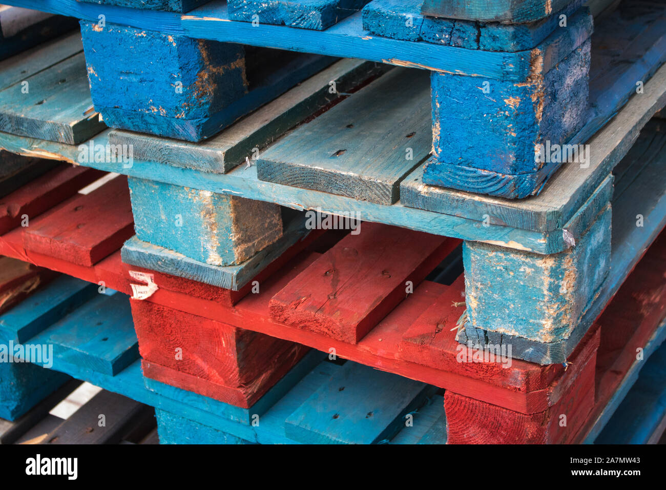 Wooden Pallets In Color Blue Light Red Closeup on a streed slighty used ...