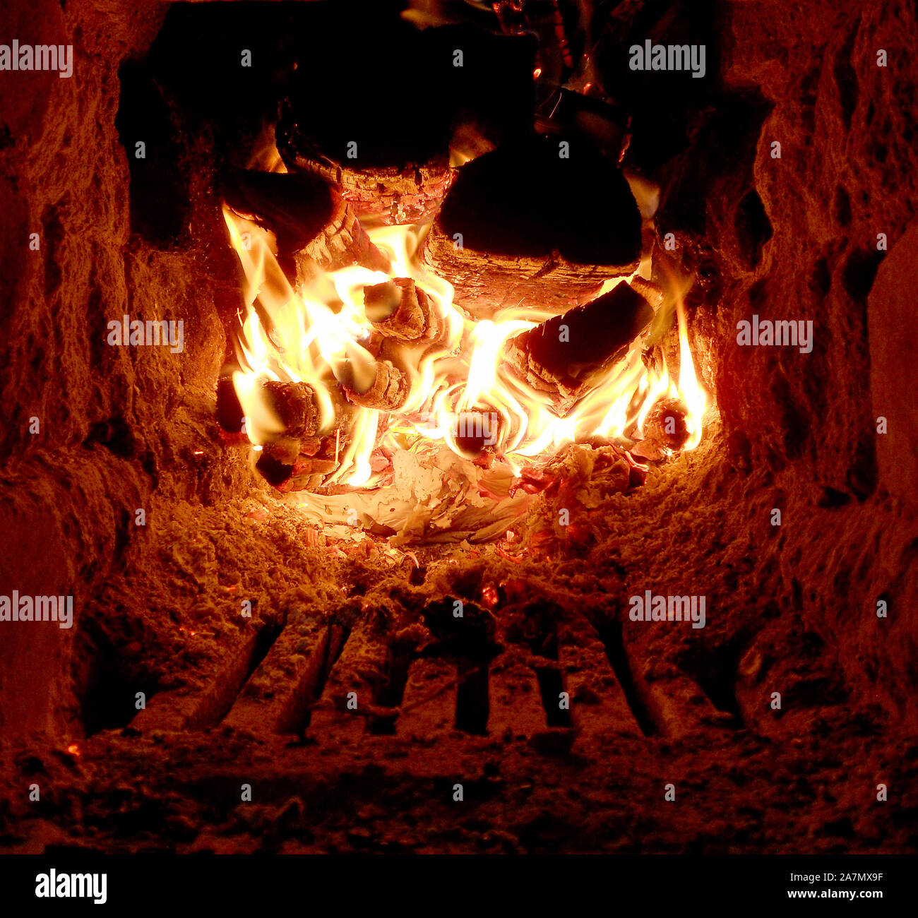 Beautiful red fire from slice wood, dark grey black coals inside metal ...