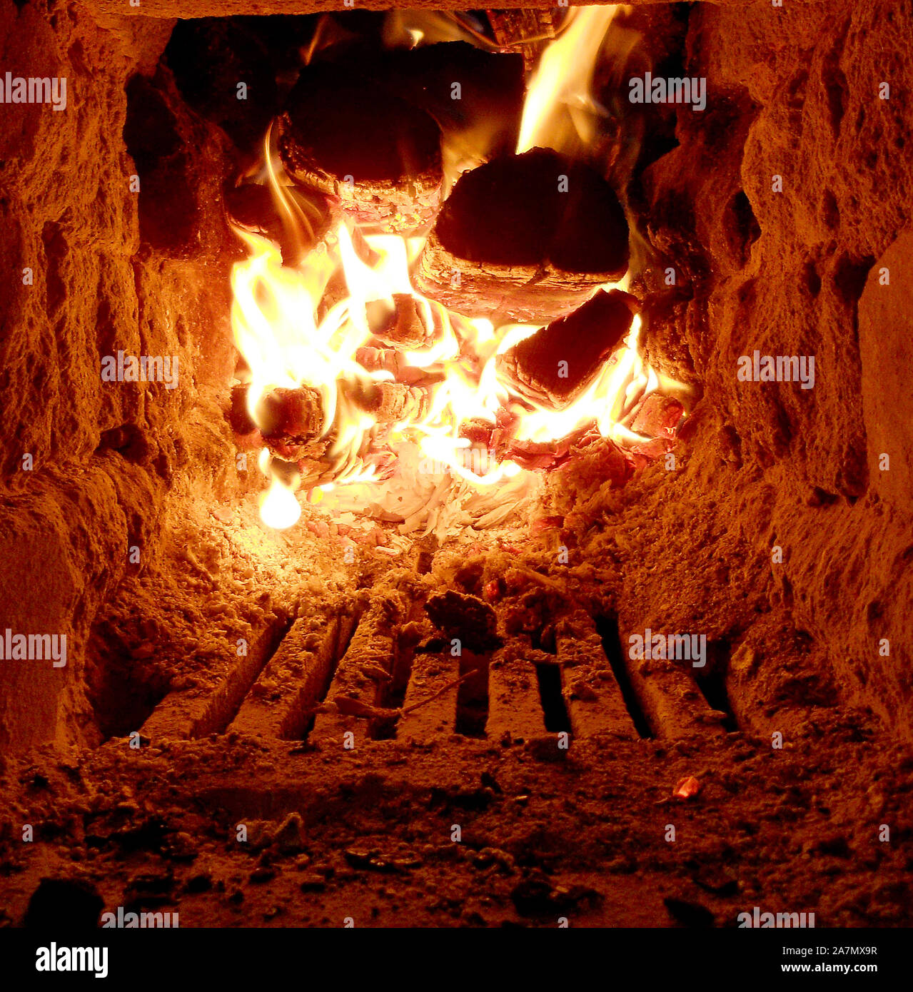 Beautiful red fire from slice wood, dark grey black coals inside metal ...