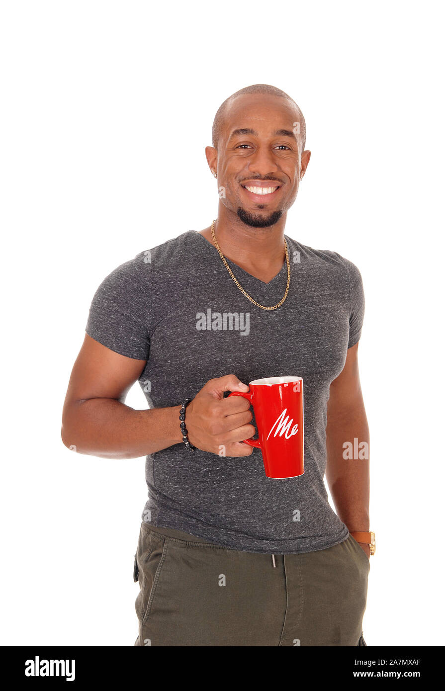 A handsome young African American man standing smiling in the studio ...