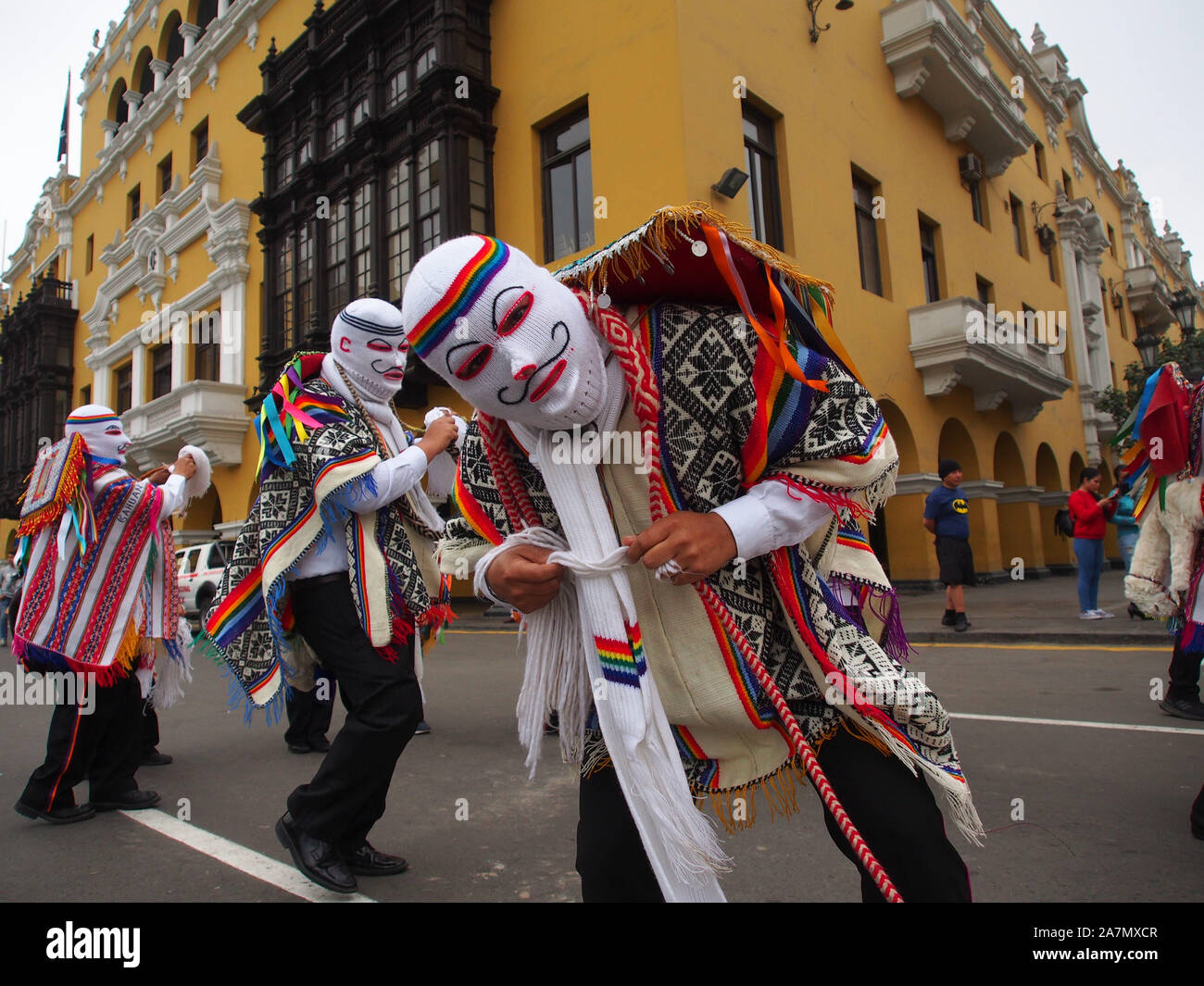 A masked folk dancer wearing typical costume participating in the ...