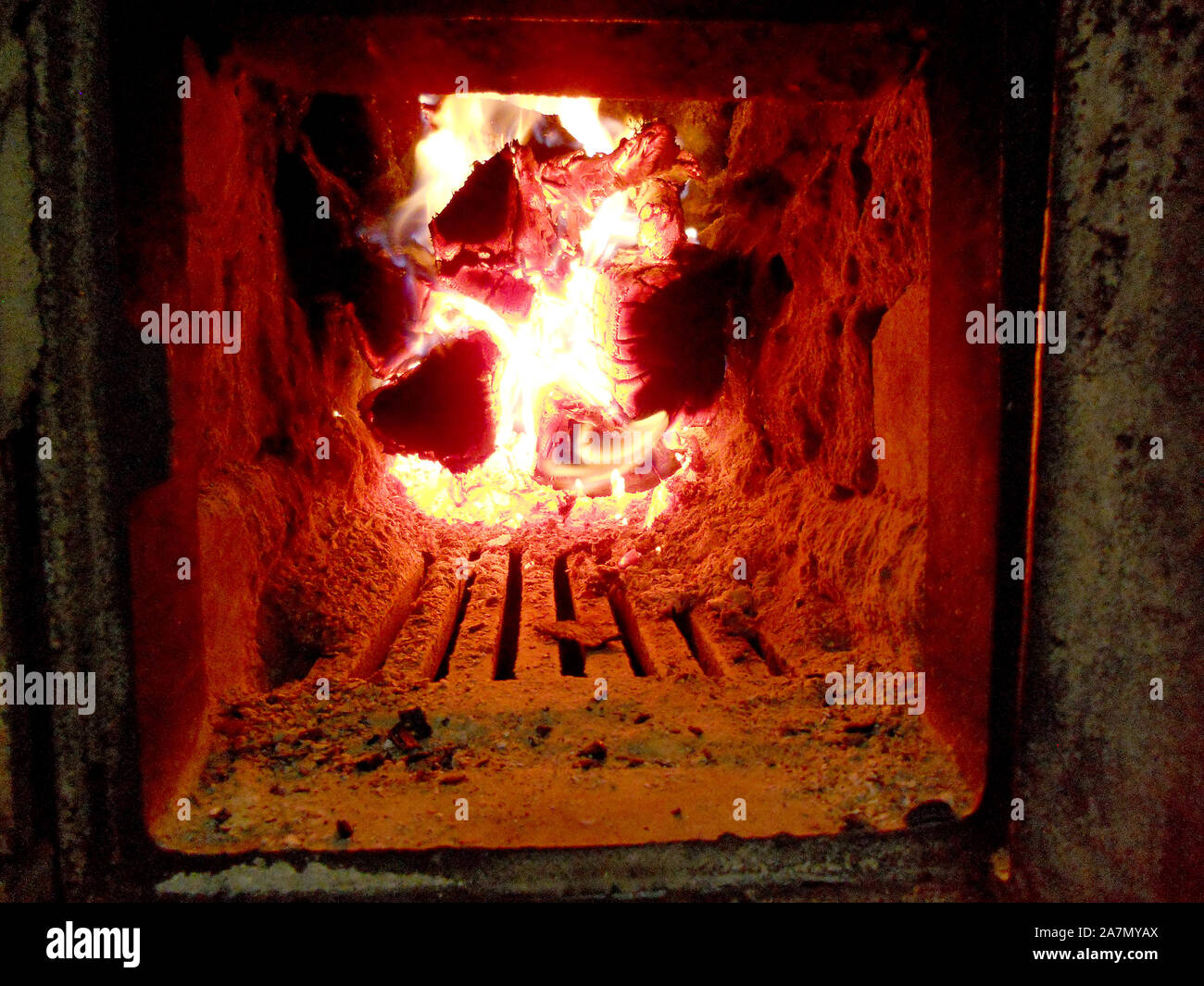 Beautiful red fire from slice wood, dark grey black coals inside metal ...