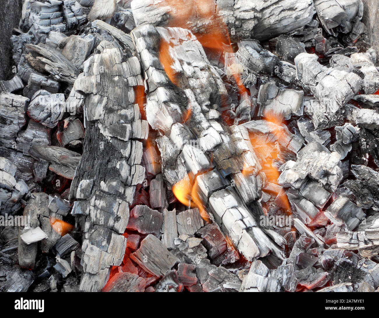 Beautiful red flame from slice wood, dark grey black coals inside metal ...