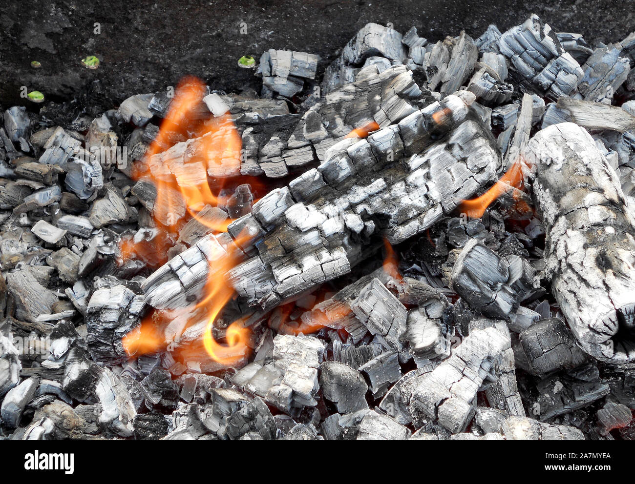 Beautiful red flame from slice wood, dark grey black coals inside metal ...