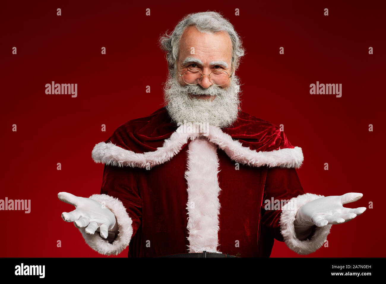 Waist up portrait of classic Santa Claus welcoming guests holding arms ...