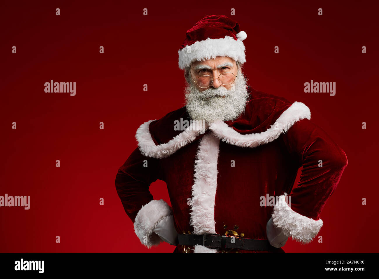 Waist up portrait of frowning Santa Claus standing with hands on hips ...