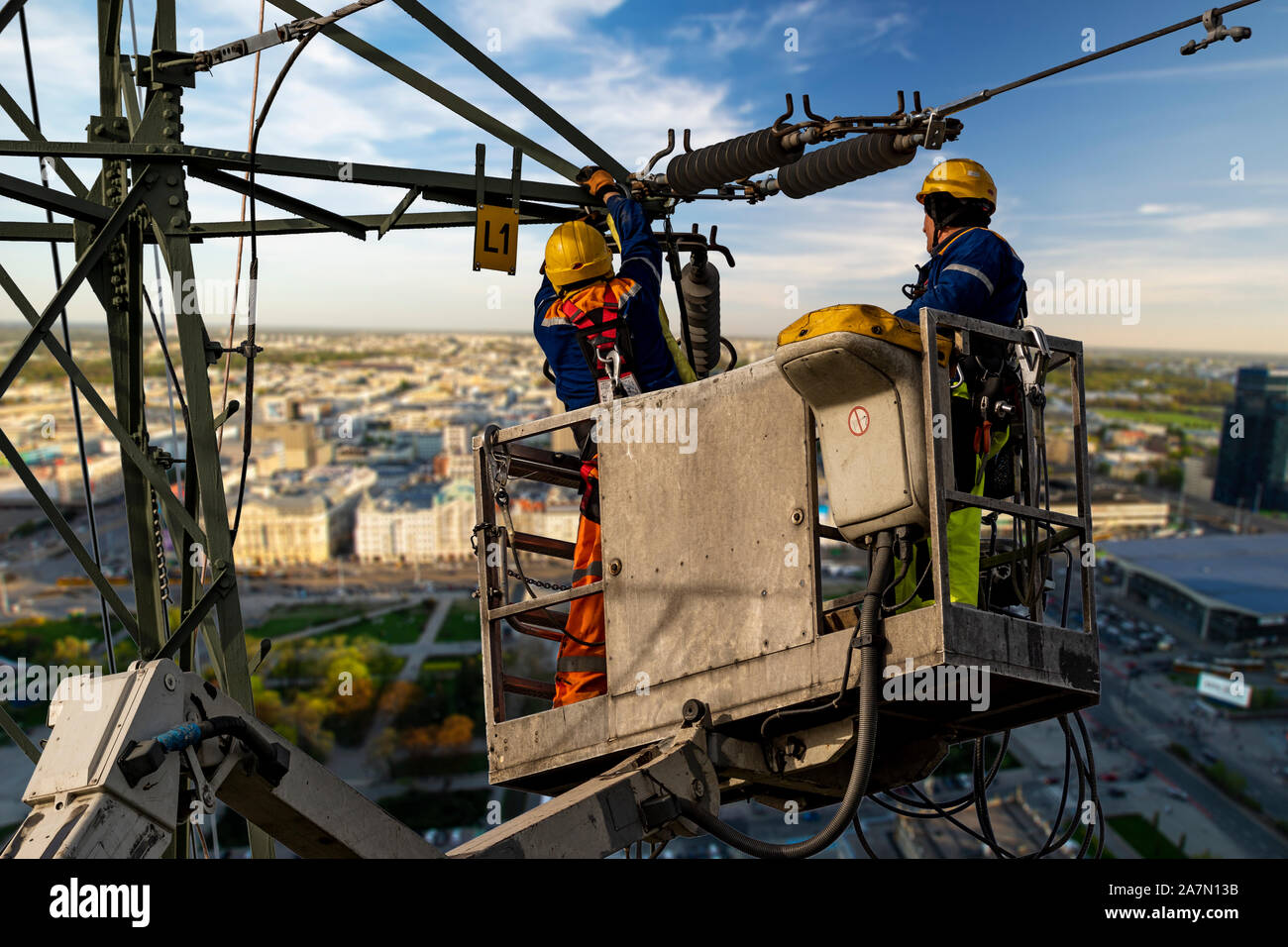 Electrical engineer repairing the electrical network on an elevation ...