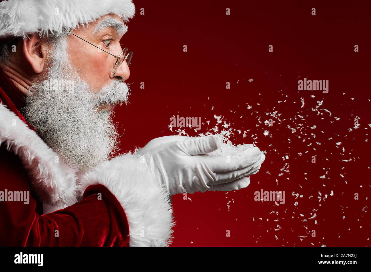 Side view portrait of classic Santa Claus blowing snow while standing ...