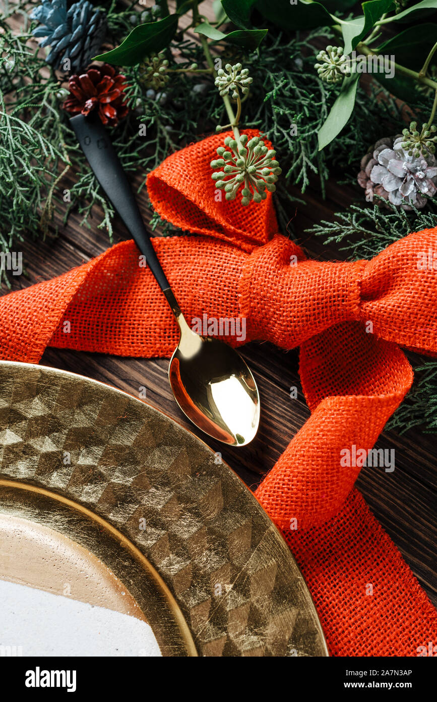 Holiday Gold place setting, spoon detail, table decorated with natural ...