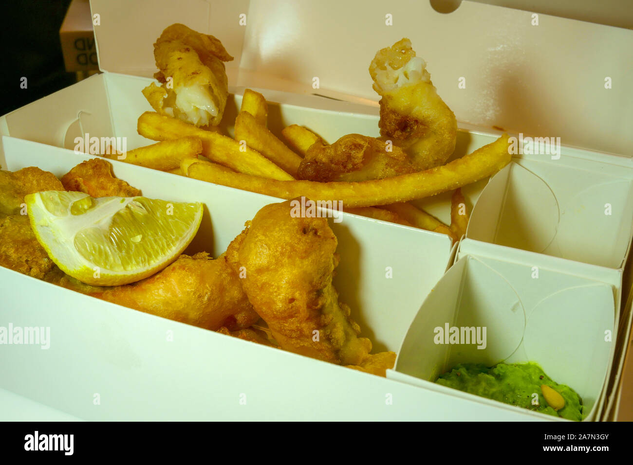 Traditional english or british takeout food - fish and chips with mushy ...