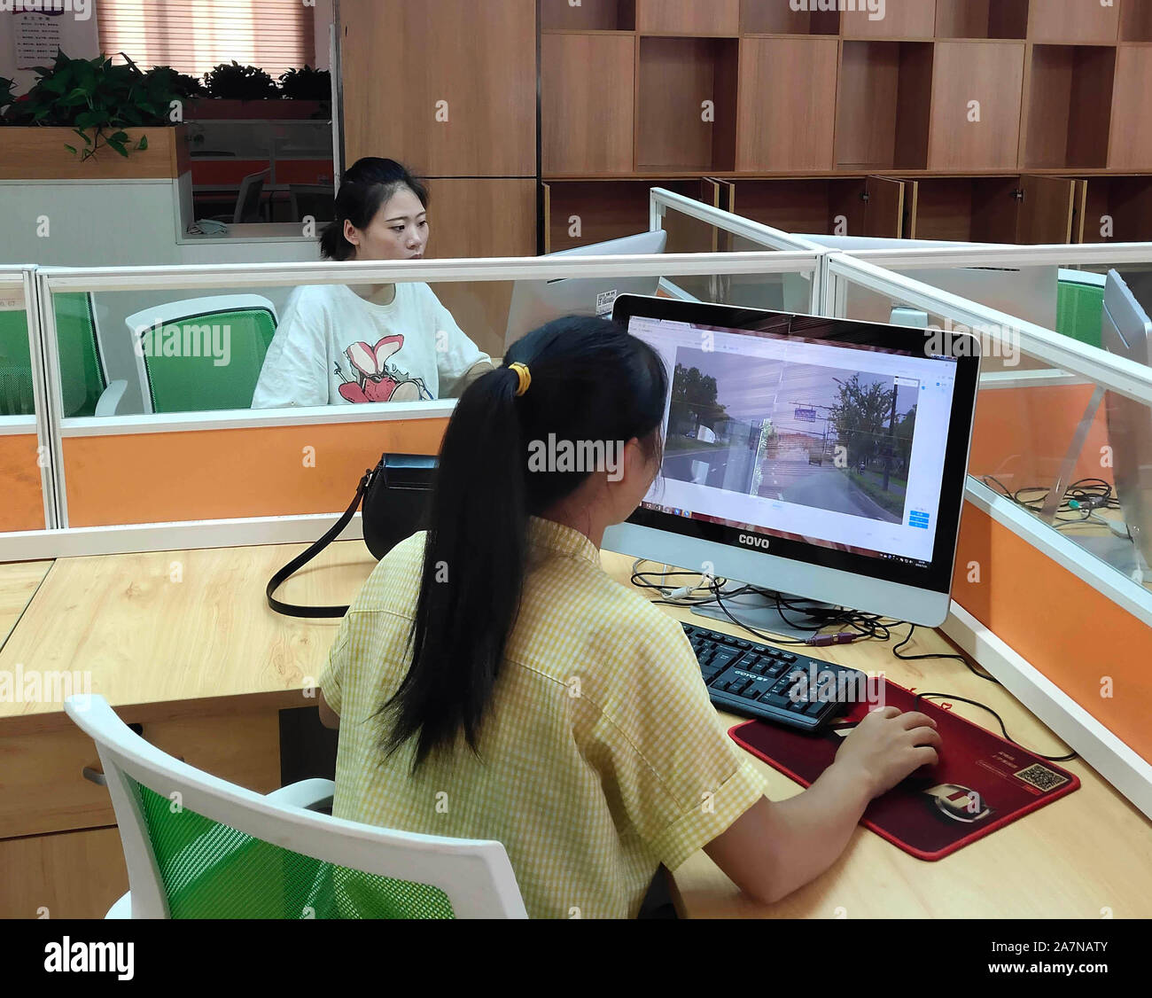 23-year-old Chinese girl Wang Hongmei and her colleague categorize and label huge amounts of ...