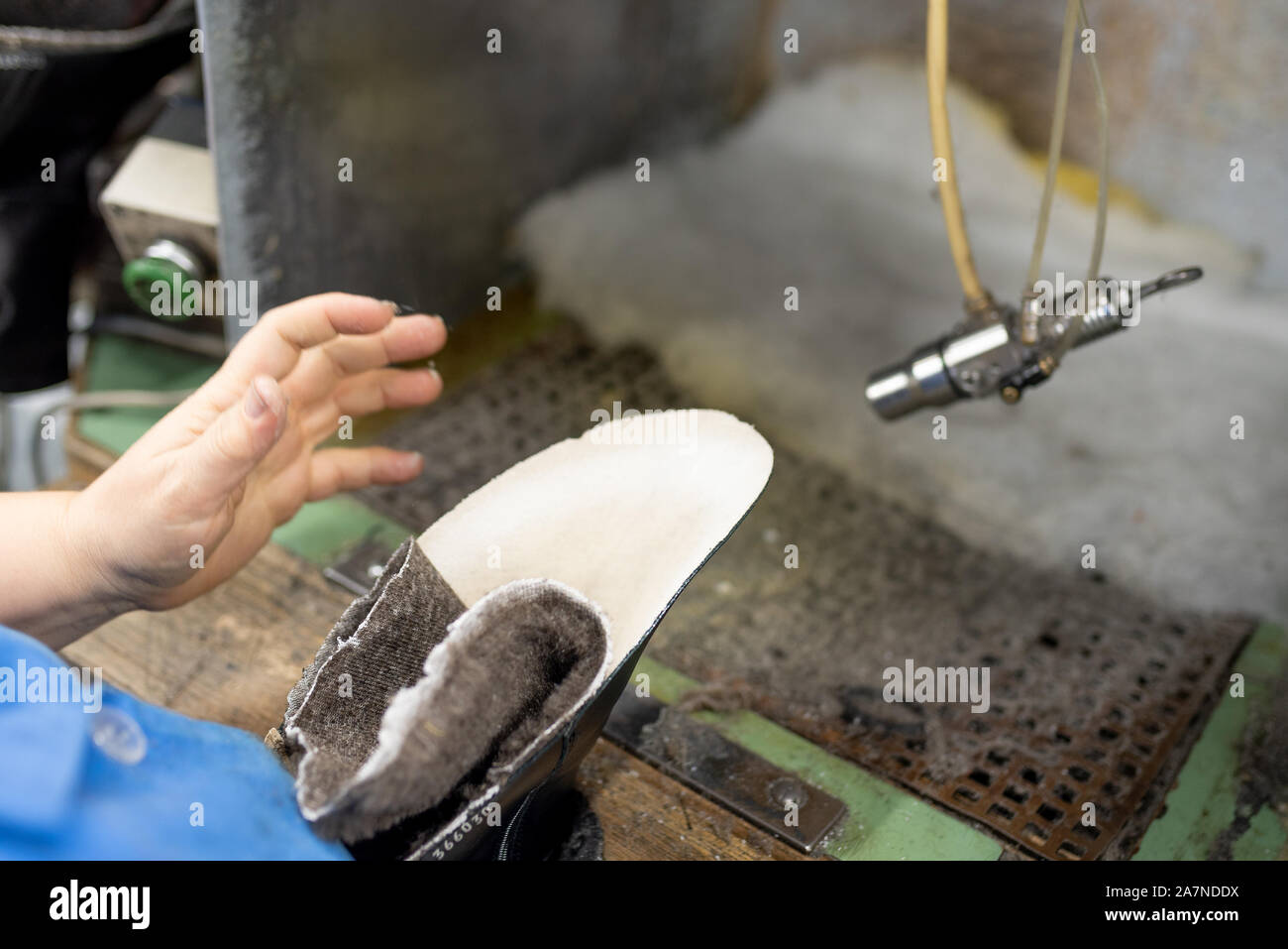 Forming the front part on a special machine. Shoe production Stock ...