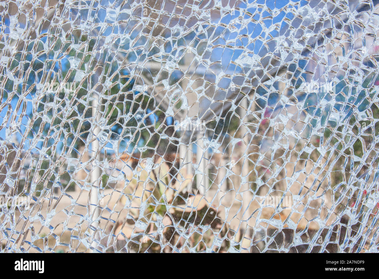 Broken glass surface with garden background at bottom. Double layer ...