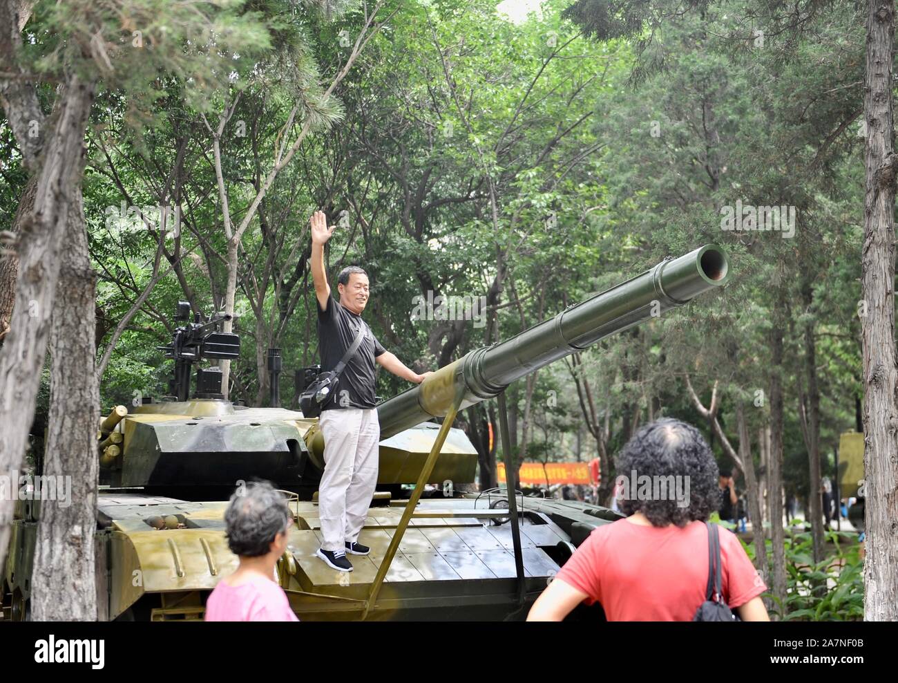 Citizens pose to photo with warcraft, tank, machine gun and other army ...