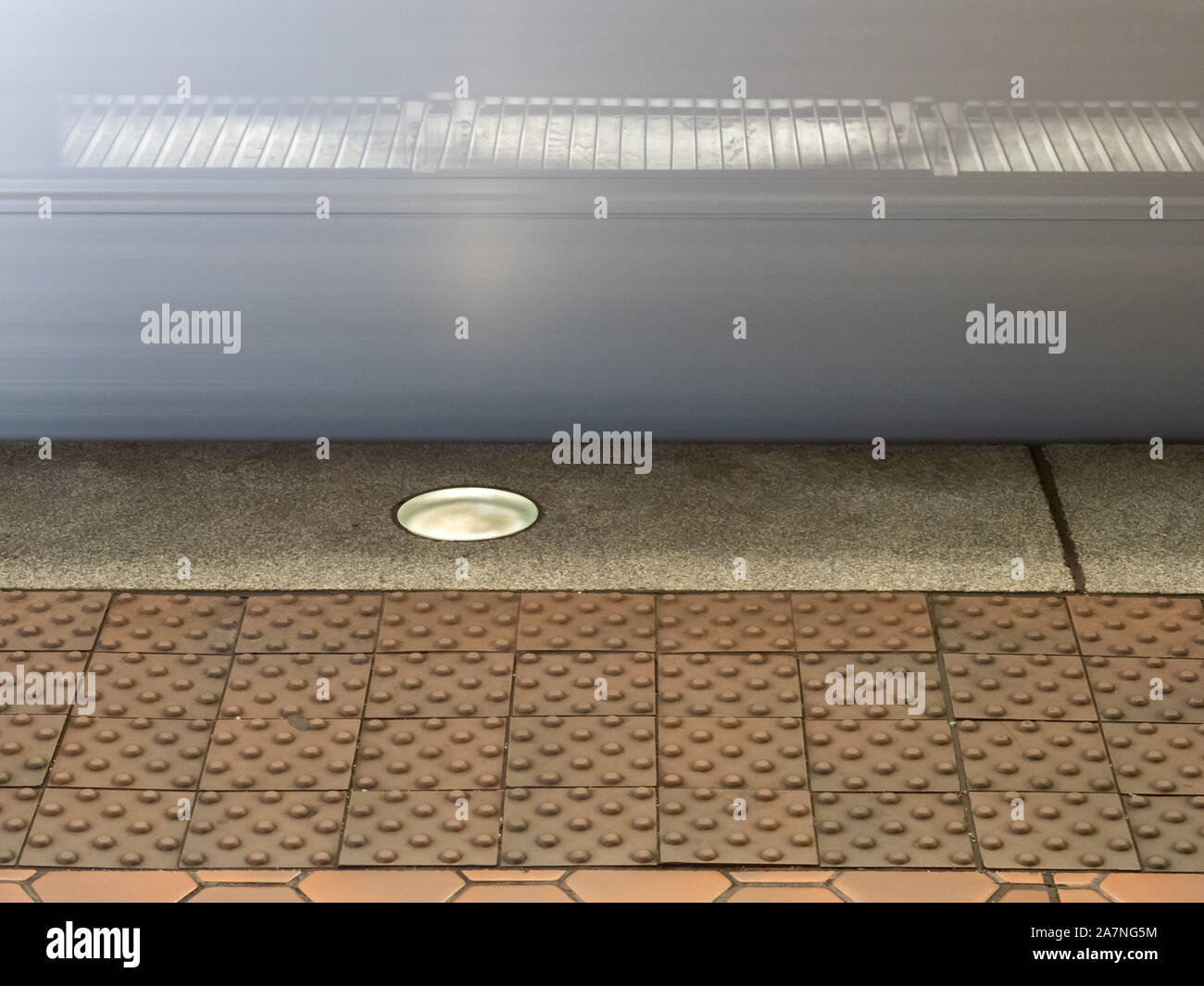 Public transit subway train moving past dark lighted platform Stock ...