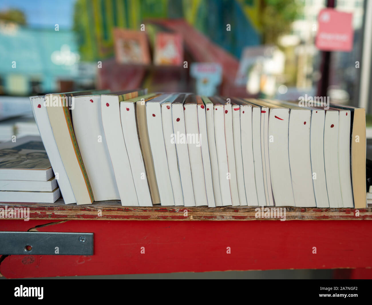 Row of used books sitting on shelf outside of a shop store front Stock ...