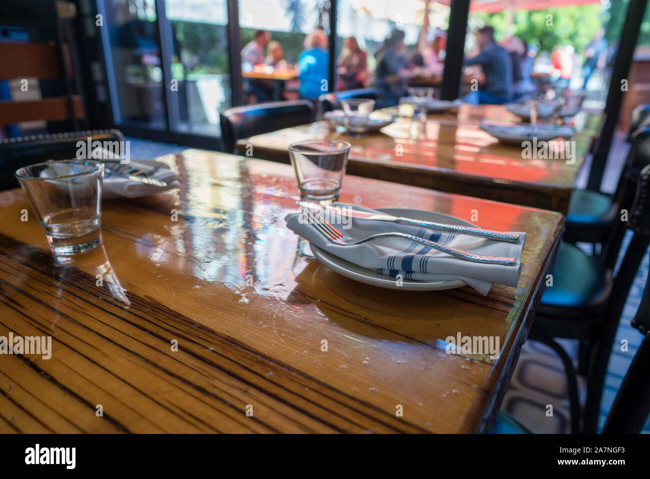 Table setting of cups, napkins, plates, and utensils in casual ...