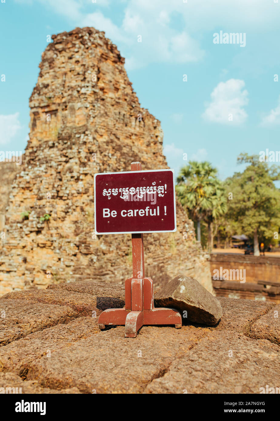 Be Careful Warning sign in Angkor Wat Temple Stock Photo - Alamy