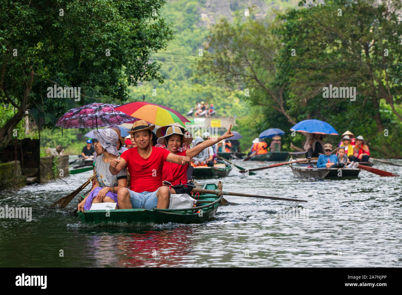 Tam Coc, Vietnam, 16th October 2019: Asian tourists travel on a rowing ...