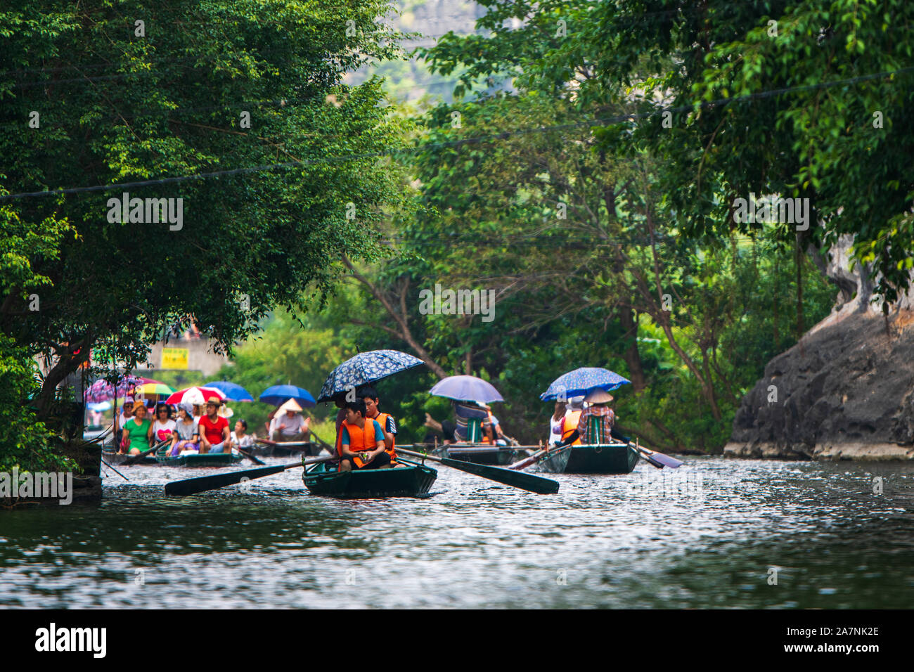 Tam Coc, Vietnam, 16th October 2019: Asian tourists travel on a rowing ...
