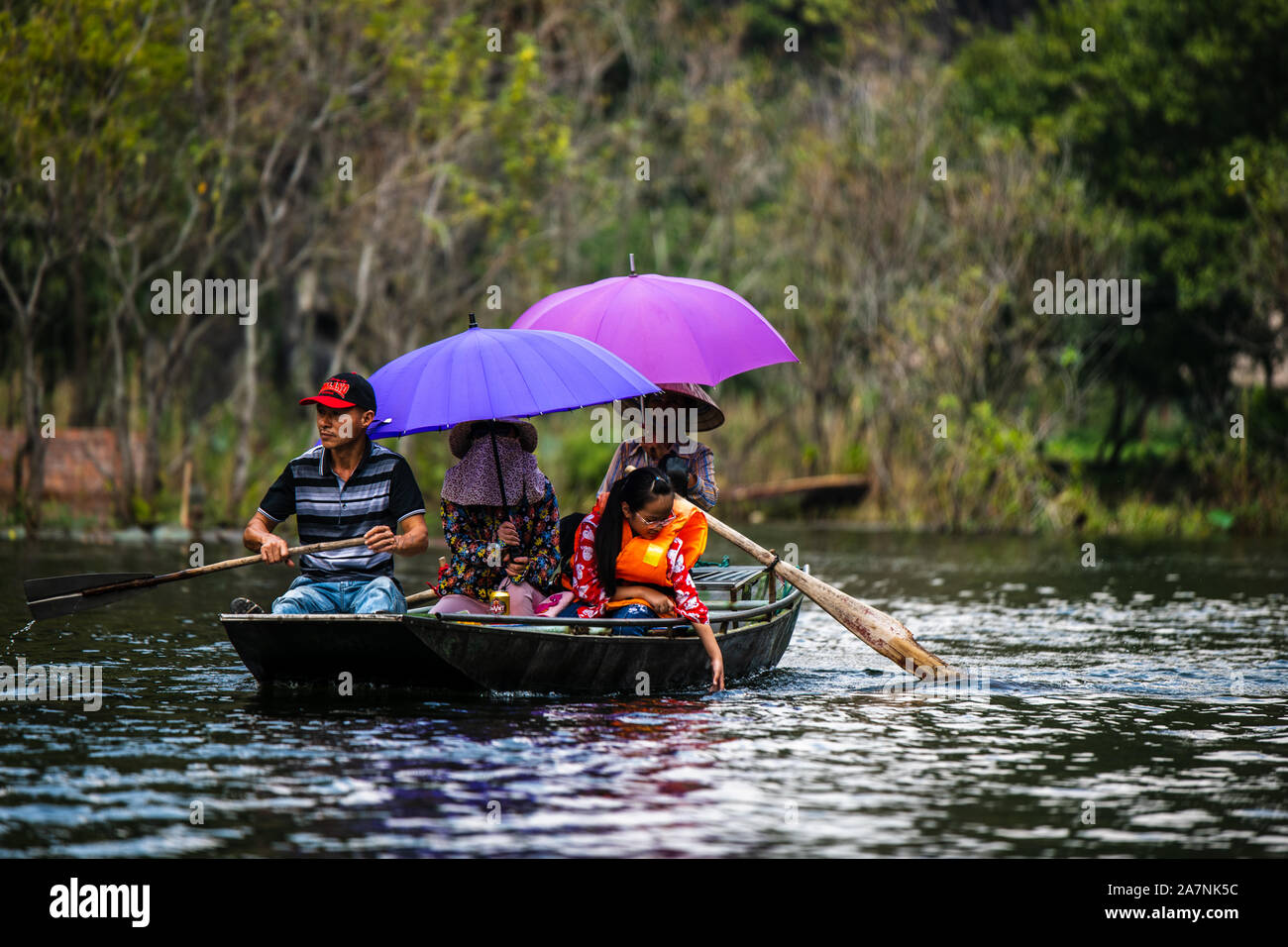 Tam Coc, Vietnam, 16th October 2019: Asian tourists travel on a rowing ...