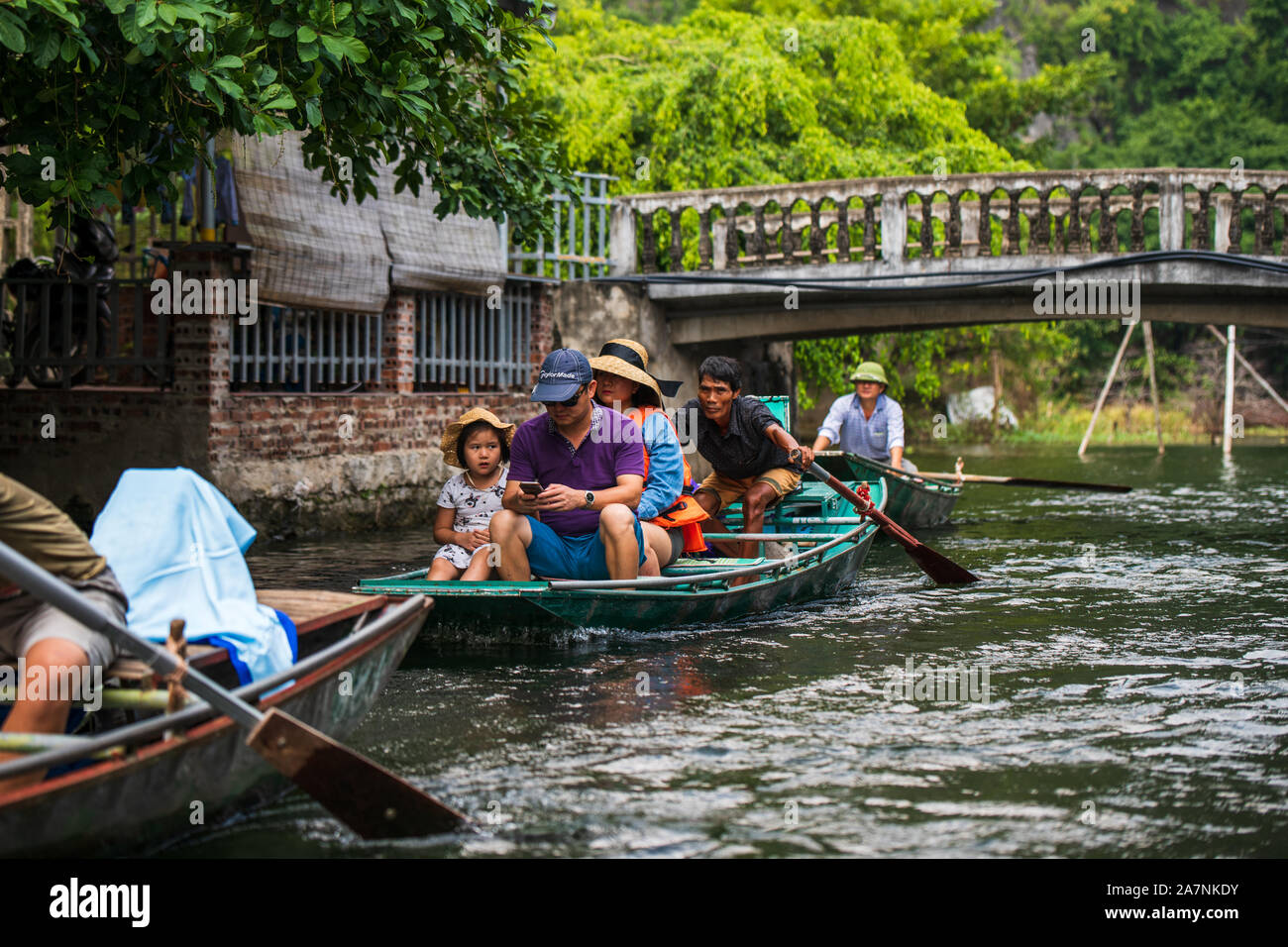 Tam Coc, Vietnam, 16th October 2019: Asian tourists travel on a rowing ...