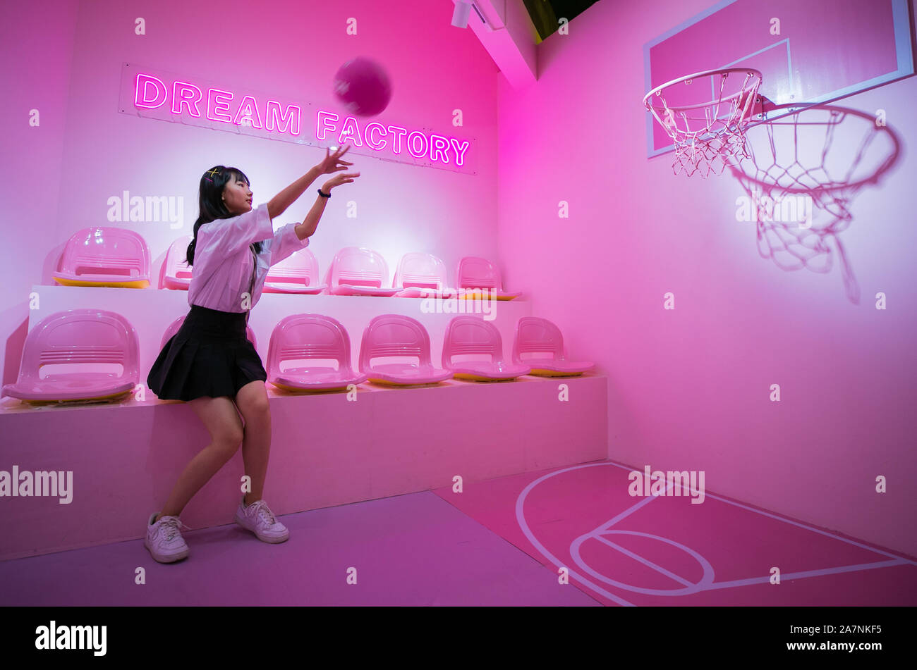 A visitor poses for photos with art installations at the Daydream ...