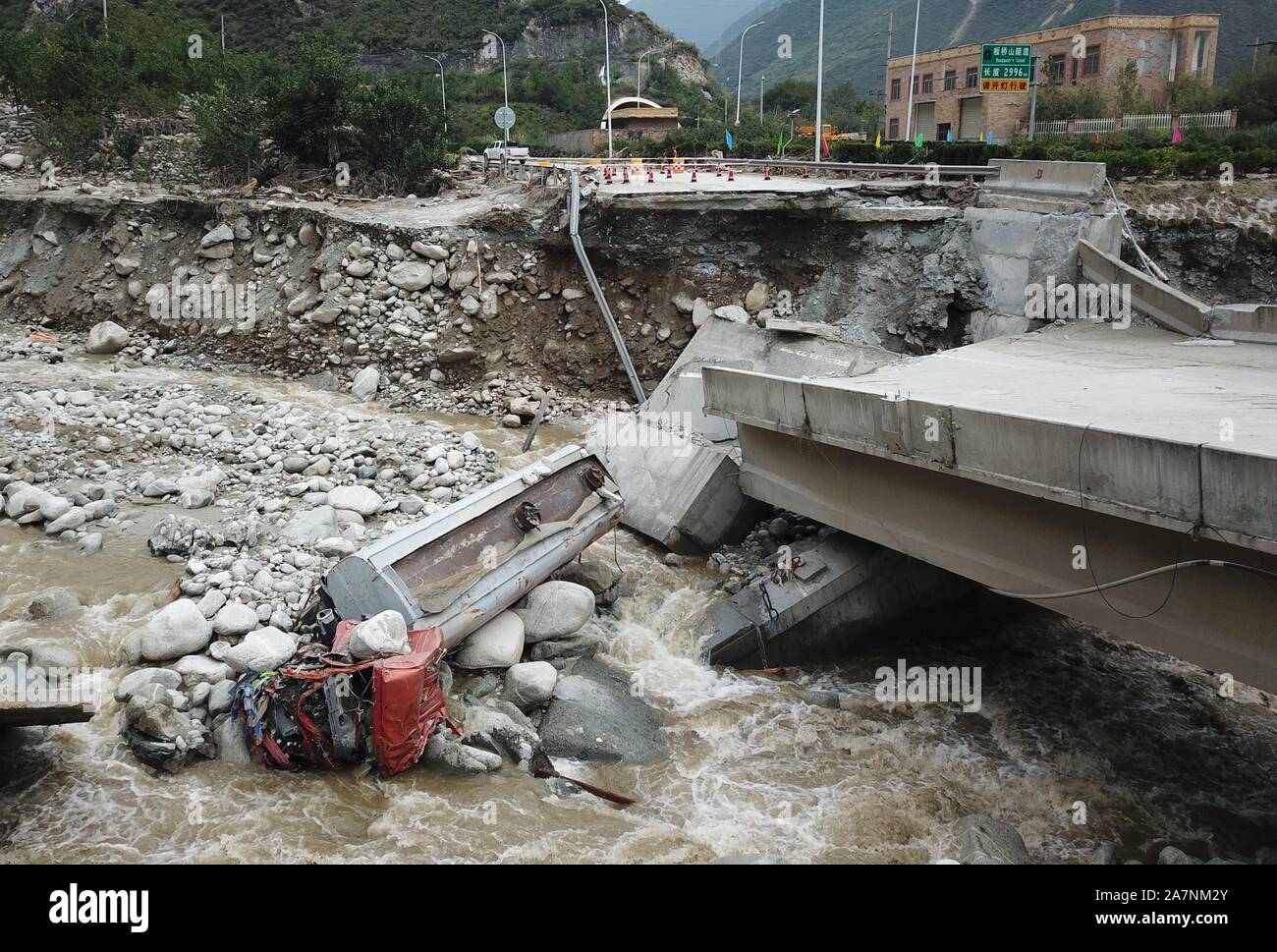 Aerial view of collapsed viaduct and overturned truck due to mudslide in Wenchuan county, Aba ...