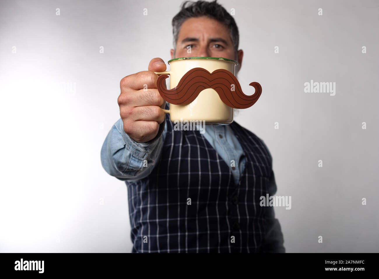 Close-up of a cup with a fake paper mustache on white background Stock ...