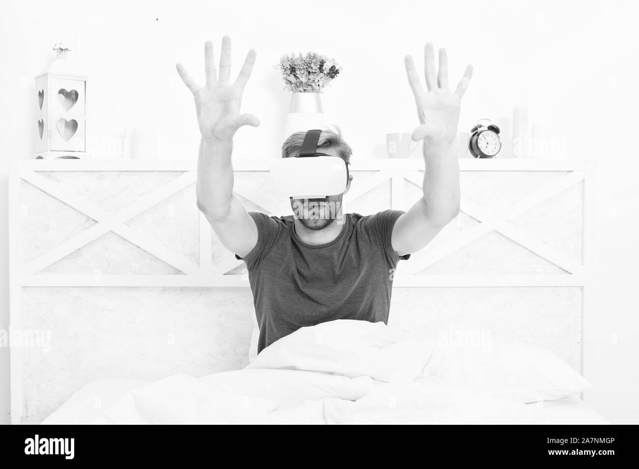 The best VR experience. Handsome guy wearing VR headset in bed ... The best VR experience. Handsome guy wearing VR headset in bed ...