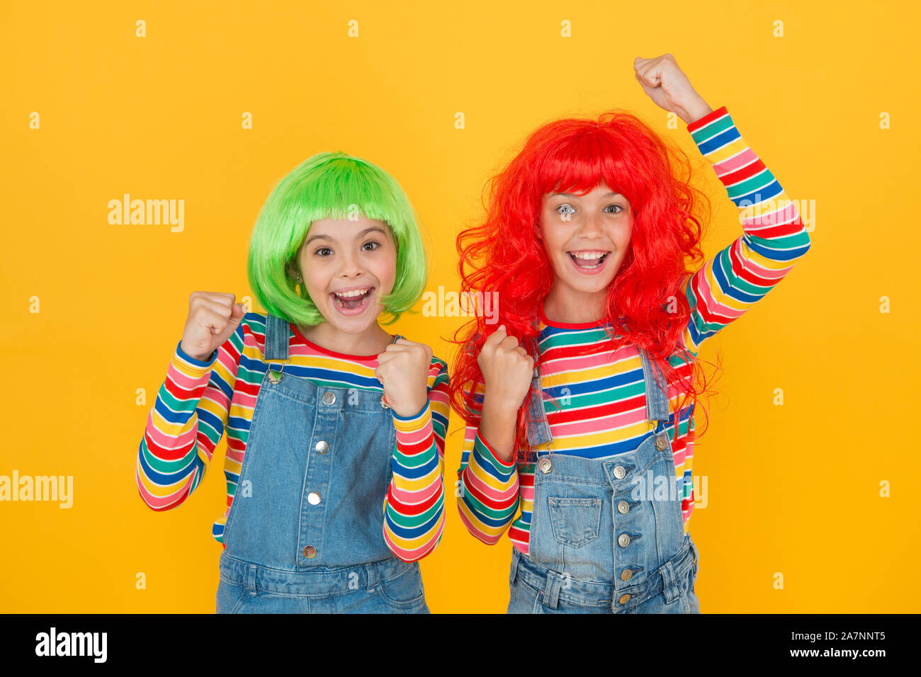 Being happy. Happy children make victory gestures yellow background ...