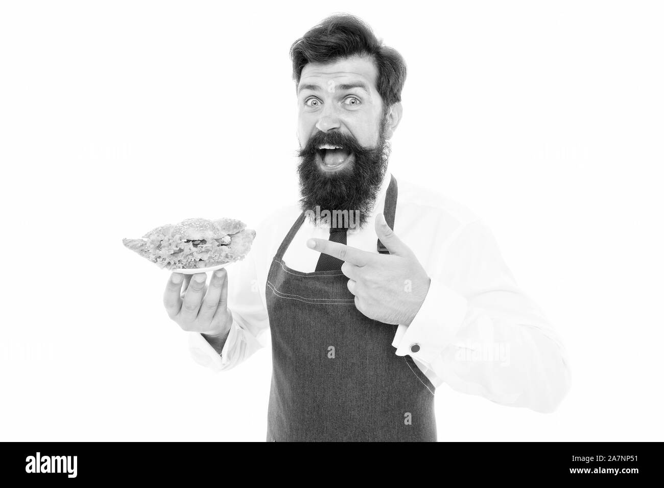 Guy serving croissant stuffed with lettuce and fresh vegetables ...