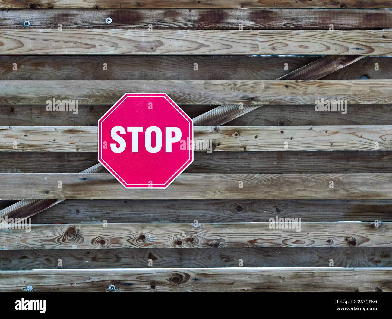 Close-up of stop road sign on horizontal pine wood fence wall Stock ...