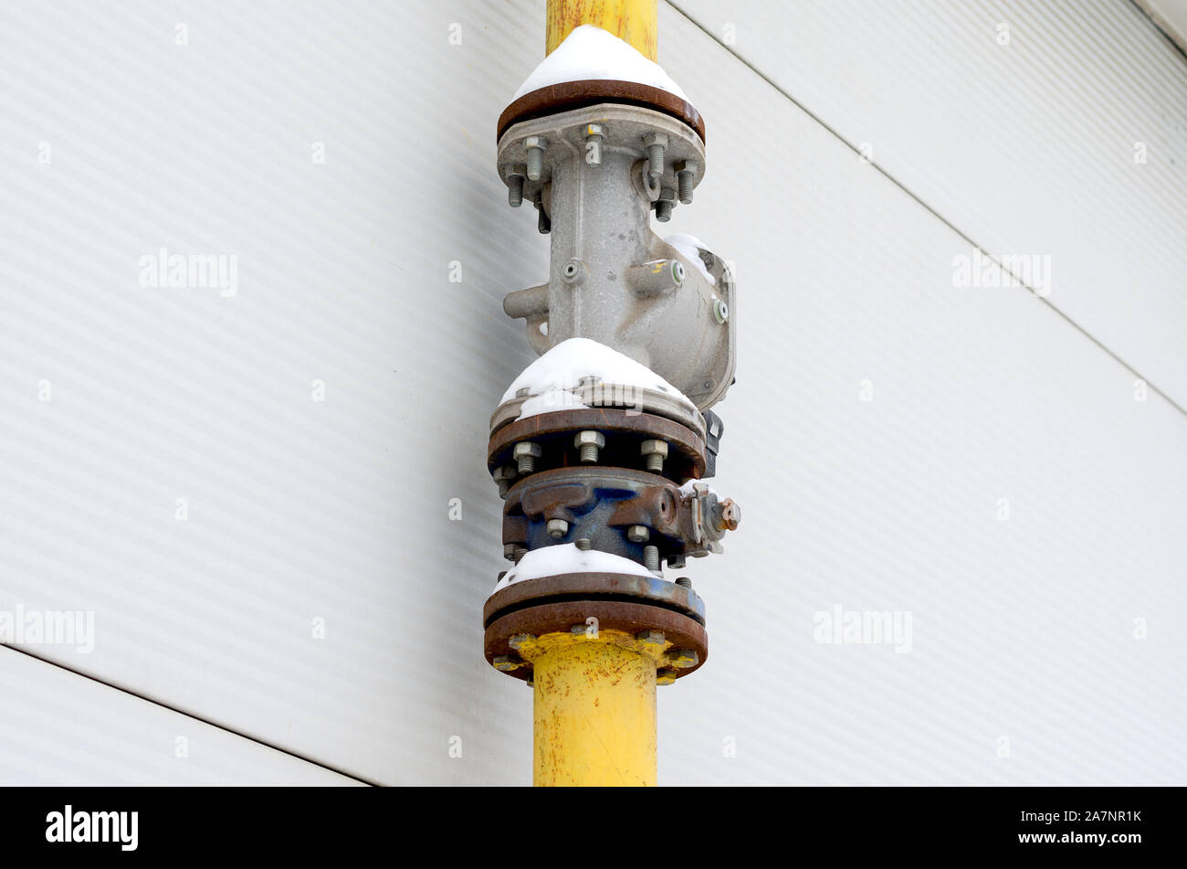 Low angle view of vertical gas pipe with valve nuts and bolts against ...