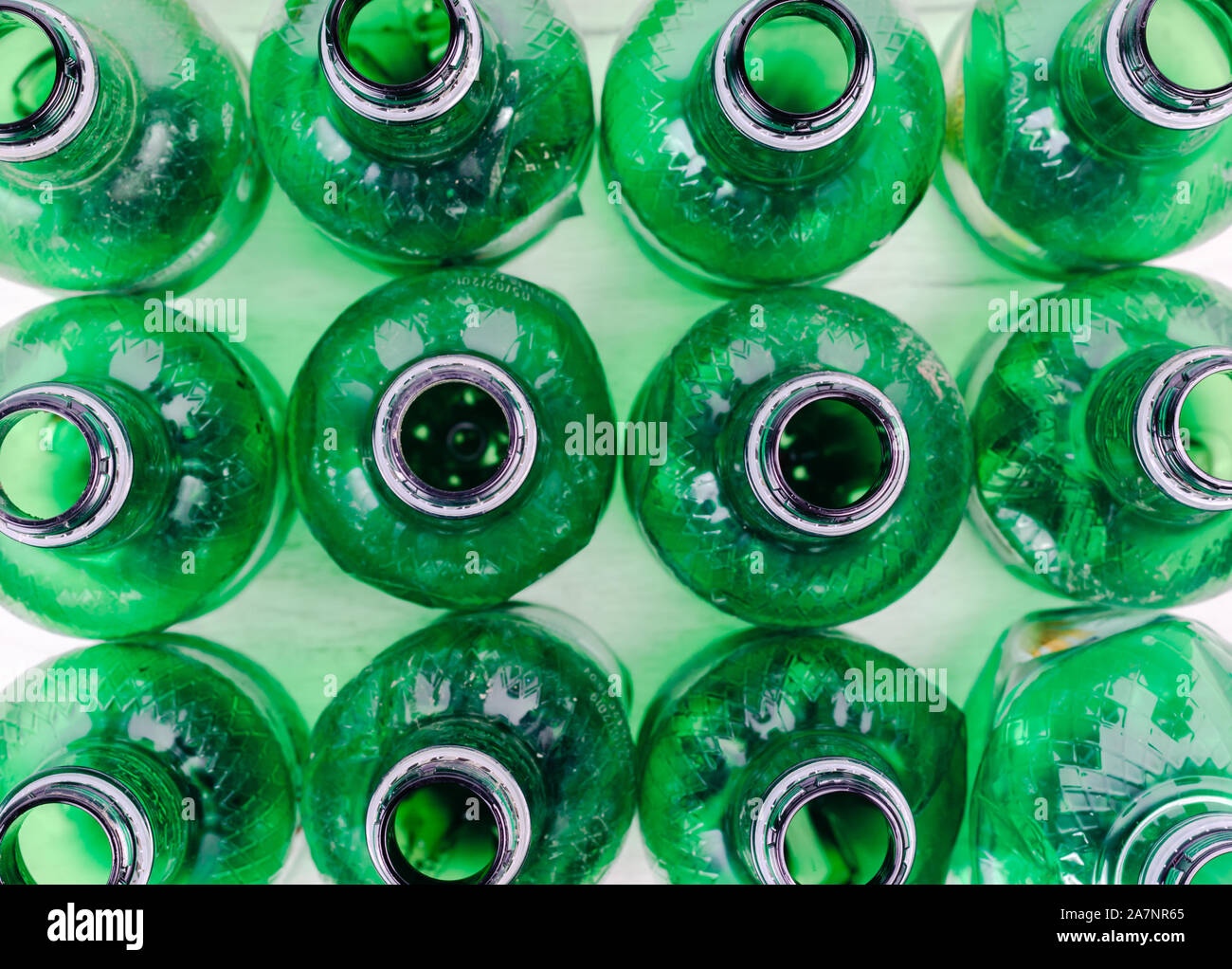 Overhead close up of green plastic bottles without caps on table Stock ...