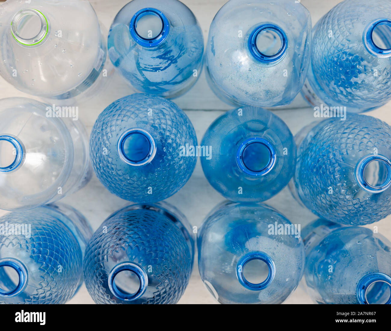 Full frame high angle view shot of blue empty glass bottles on table ...
