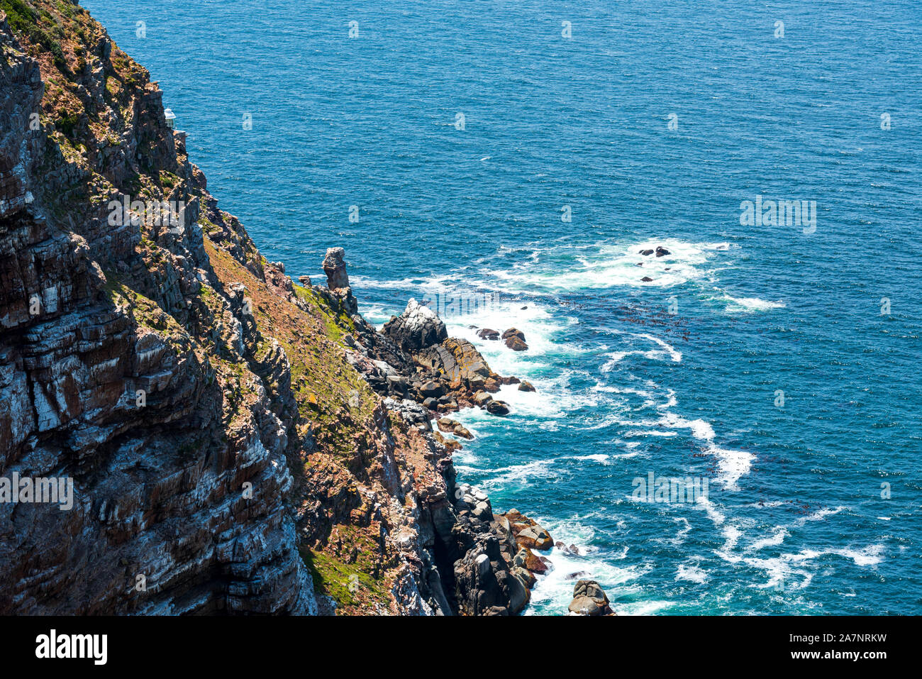 Looking down a very steep cliff to the ocean below at the Cape of Good ...