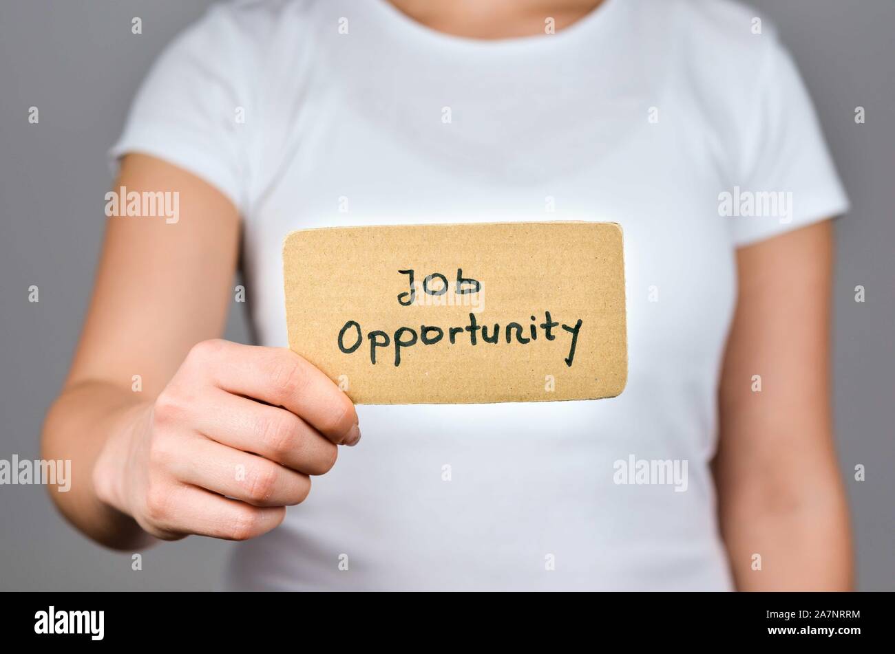 Job Opportunity phrase handwritten on square cardboard paper holding by ...