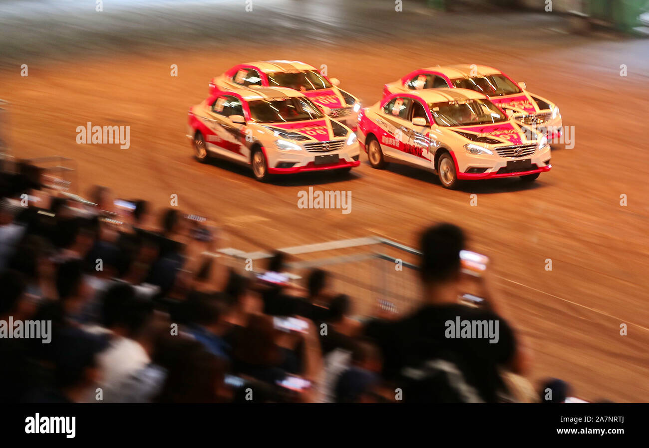Members of car racing acrobatic teams perform during the reopening ...